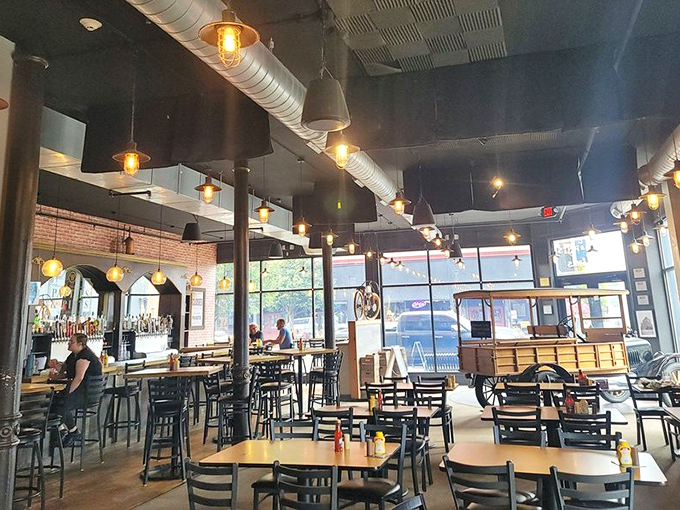 Industrial-chic meets hometown comfort inside, where exposed ductwork, pendant lighting, and brick walls create the perfect backdrop for serious eating and drinking.