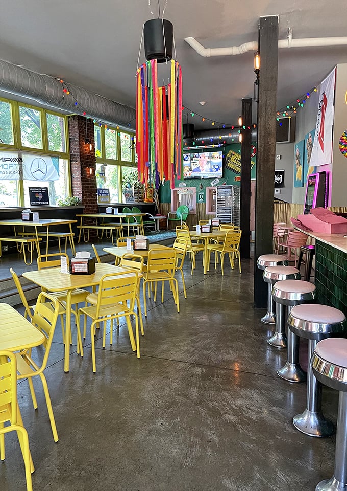 Sunshine streams through floor-to-ceiling windows while colorful streamers dance overhead. If joy were a room, it would look exactly like this.