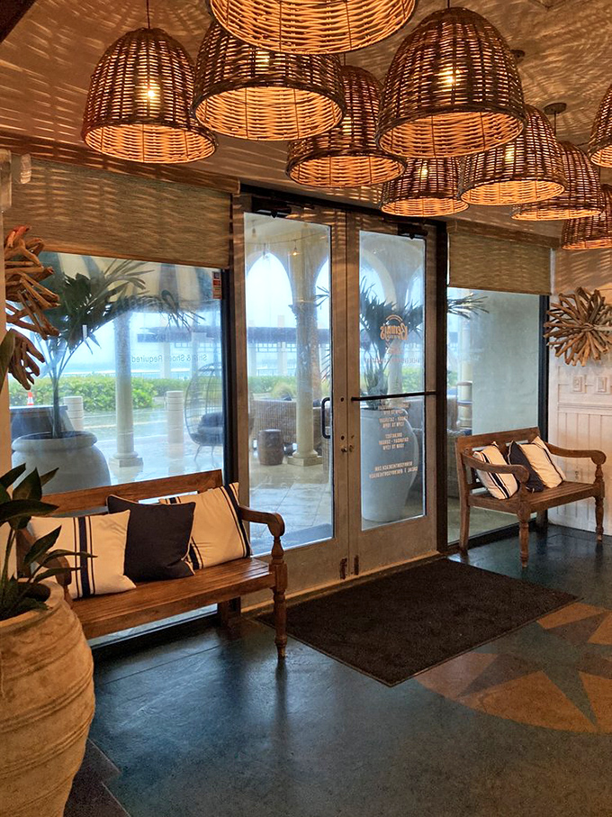 Palm trees sway outside while wicker pendant lights cast a golden glow inside—Mother Nature and interior designers working in perfect harmony.