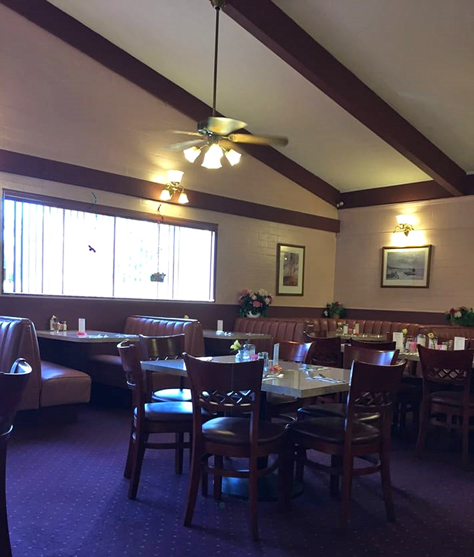 College pennants dance overhead while exposed ductwork meets warm red walls&mdash;a dining room where Louisiana spirit meets Florida hospitality.