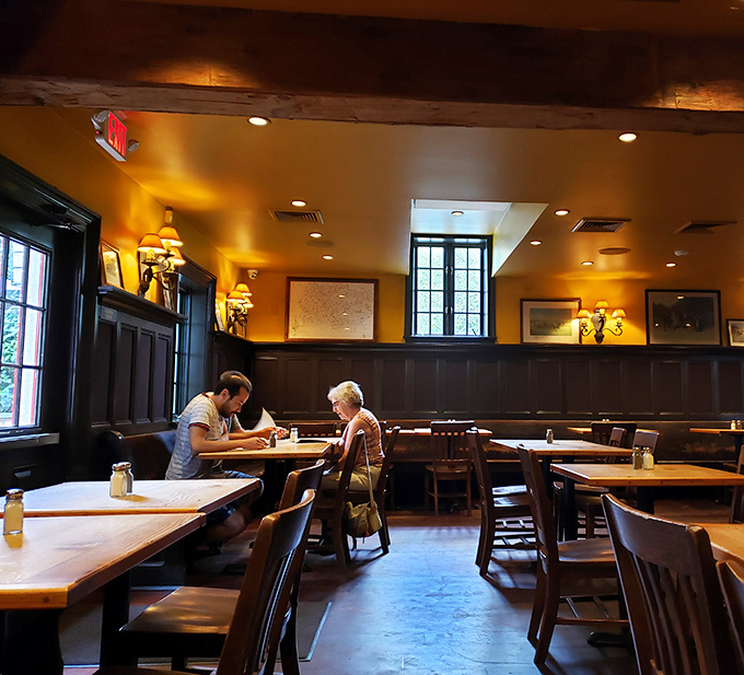 Dark wood paneling, warm golden walls, and exposed beams create the perfect setting for long conversations and longer meals. You'll swear you've been teleported across the Atlantic.