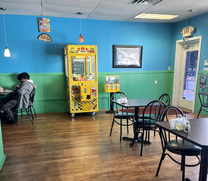 Turquoise walls and green wainscoting create a slice of Caribbean charm, complete with a claw machine that seems to say, "Stay for dessert, win a prize!"