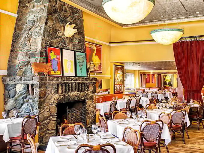 Yellow walls, vintage posters, and that magnificent stone fireplace &ndash; this dining room doesn't just serve French cuisine, it wraps you in a Parisian embrace.