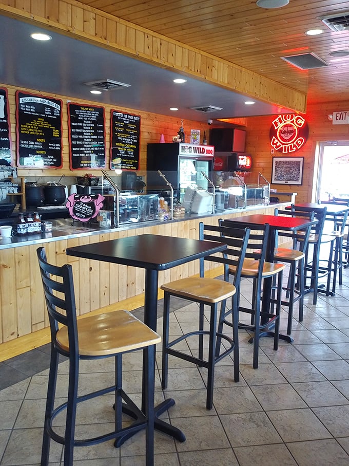 Wood-paneled walls and straightforward seating say, "We're serious about the food, not the furniture." The neon Hog Wild sign glows like a promise of smoky delights to come.