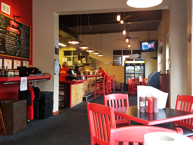 The bright red chairs aren't just a design choice—they're preparing you for the bold flavors waiting in the kitchen. Comfort meets craft in this welcoming space.