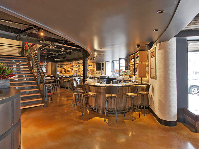 The interior blends industrial chic with warm wood tones, creating that sweet spot between "fancy enough for date night" and "comfortable enough for Tuesday."