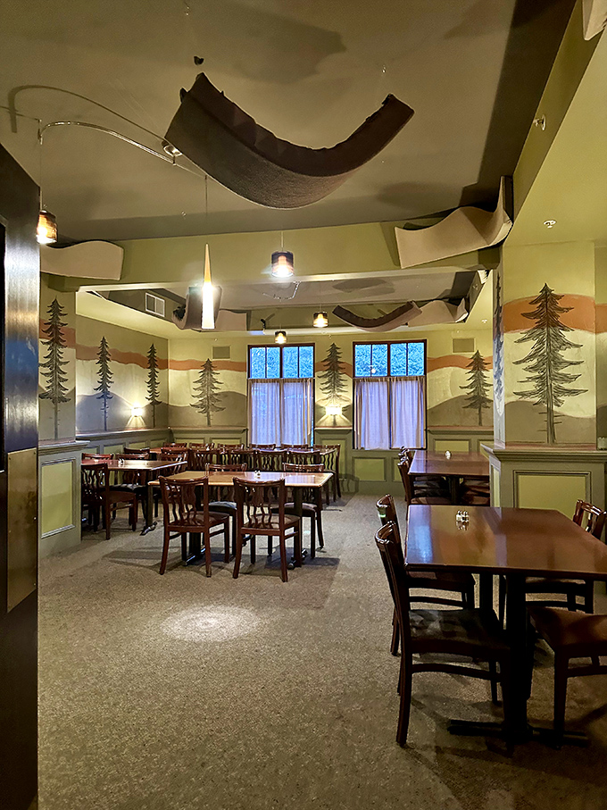 Pine trees painted on the walls and fabric canopies overhead create a whimsical forest dining experience&mdash;like eating in an enchanted woodland, but with better service.