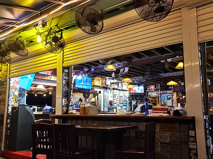 As dusk settles, the palm-fringed silhouette transforms into a beacon for seafood pilgrims. Like a Jimmy Buffett song come to life, but with better food.