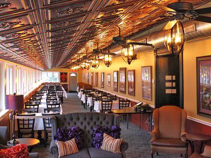 Copper ceiling tiles gleam above comfortable seating areas, creating an atmosphere that's both upscale and "come as you are" friendly.
