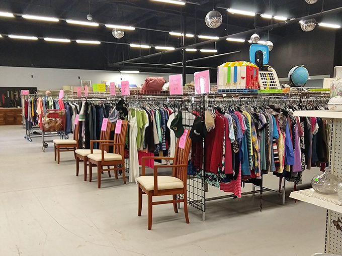 Clothing racks stretch like a textile rainbow, while disco balls overhead remind you that yes, bargain hunting should feel like a celebration.