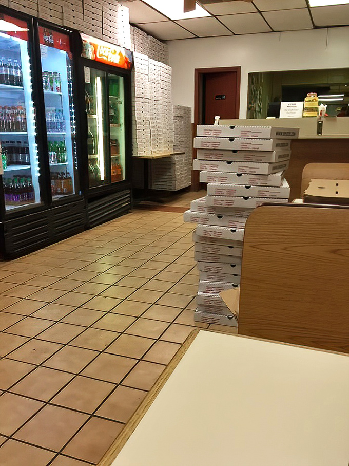 Stacks of pizza boxes await their delicious cargo. In the pizza business, a tower of empty boxes is a promise of good things to come.