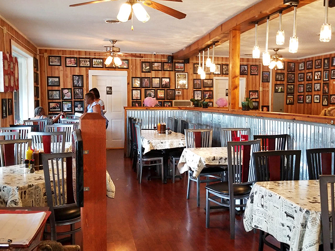 Wooden walls adorned with countless photographs create a museum of memories, while corrugated metal accents remind you this is serious barbecue business.