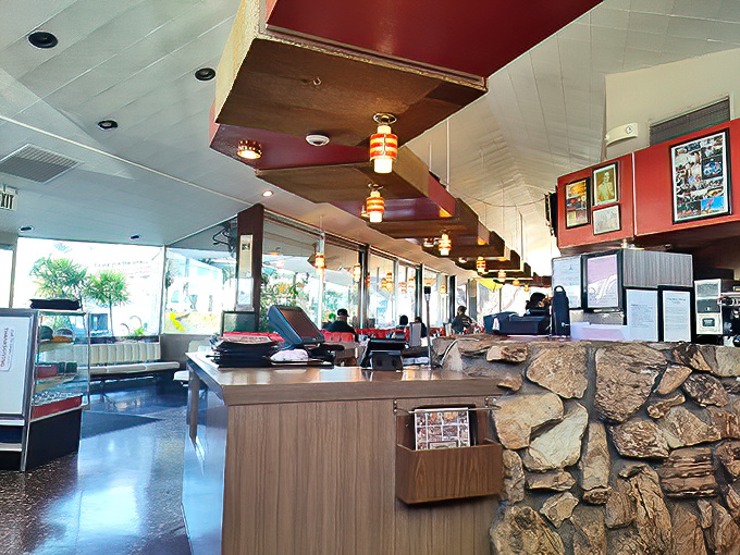 Inside, the stone walls and wood paneling create that perfect time-capsule vibe where calories don't count and coffee refills are endless.