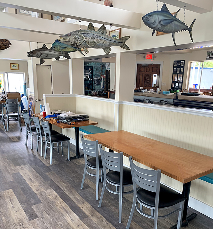Fish tales hang from the ceiling! These metallic marine masterpieces watch over diners, silently judging your seafood selection skills.