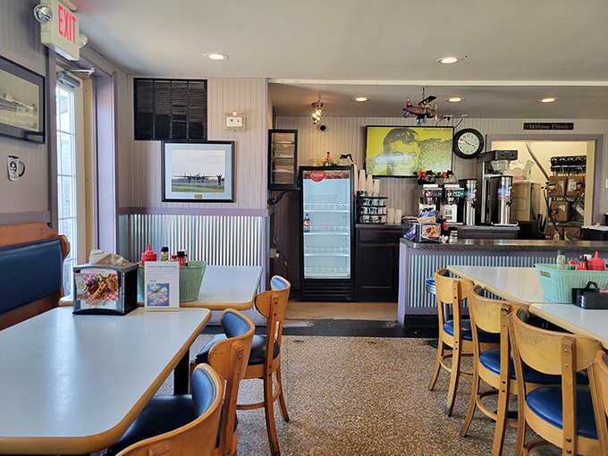 Step inside to a world where aviation memorabilia meets comfort food paradise. The corrugated metal wainscoting isn't trying to impress Architectural Digest&mdash;it's too busy supporting delicious meals.