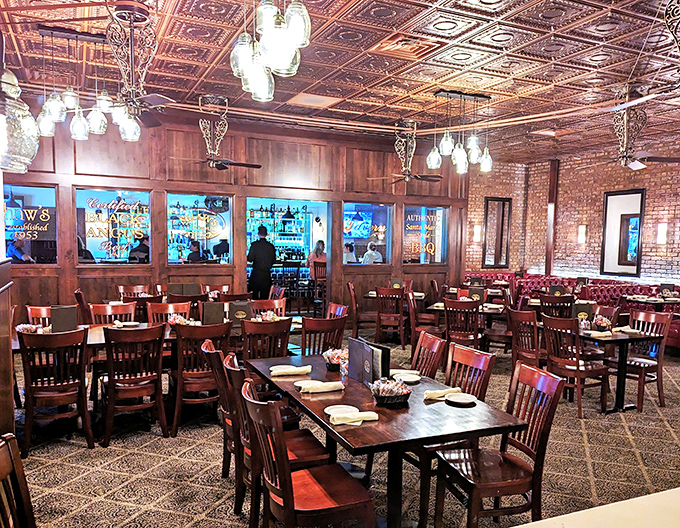 Pressed tin ceilings, warm wood paneling, and brick walls create the holy trinity of steakhouse ambiance. This isn't decoration&mdash;it's a time machine to when dining meant something.