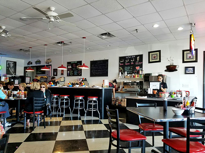 Classic black and white checkerboard floors set the stage for time travel. Those red stools have supported generations of happy diners.