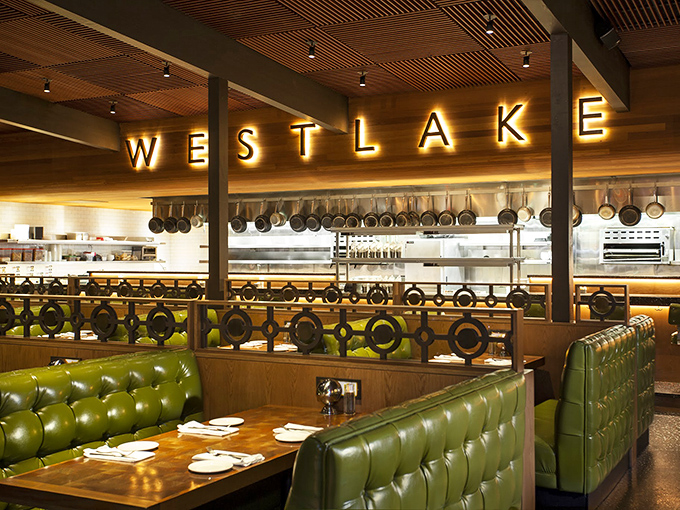 Those green leather booths aren't just seating&mdash;they're front-row tickets to culinary theater, with the exhibition kitchen's hanging pots promising delicious performances.