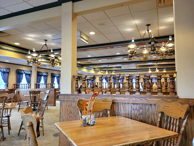 Wooden booths and blue curtains create little breakfast kingdoms where pancake dreams come true. The chandeliers cast that perfect "everyone looks well-rested" glow.