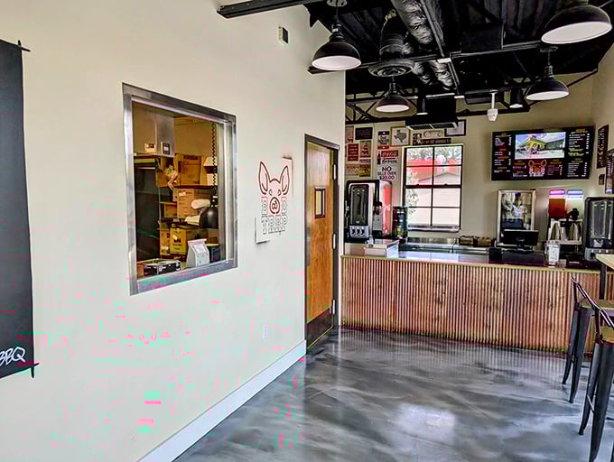Industrial chic meets meat-lover's paradise. The open kitchen window offers a tantalizing glimpse into the smoky magic happening behind the scenes, like barbecue theater for the hungry masses.