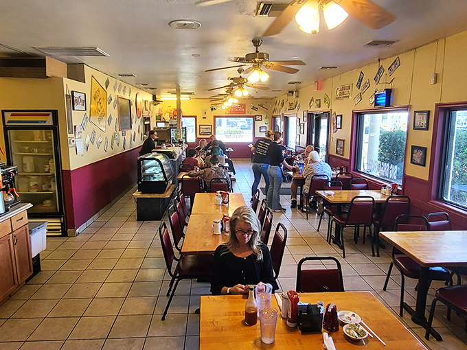 Walls dressed in vintage signs, ceiling fans humming&mdash;this cozy diner interior feels like a hug in tile and wood.
