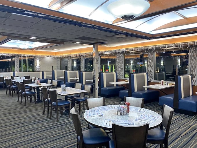 Inside, the classic diner aesthetic gets a modern update with blue and white booths that practically whisper, "Slide in and stay awhile."