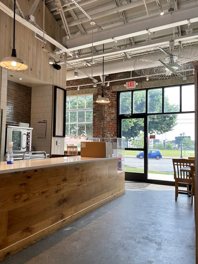 Rustic wooden counters meet industrial chic in this light-filled space where donut magic happens daily.