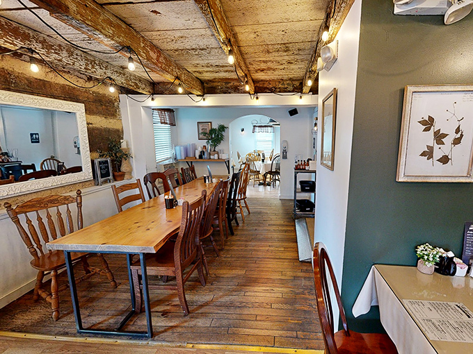 Exposed wooden beams tell a century-old story overhead while modern comfort awaits below. This dining room feels like your most stylish friend's country getaway.