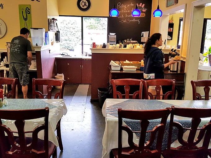 Inside, blue pendant lights cast a warm glow over wooden tables where culinary magic happens. It's like your favorite aunt's kitchen got a charming mountain makeover.