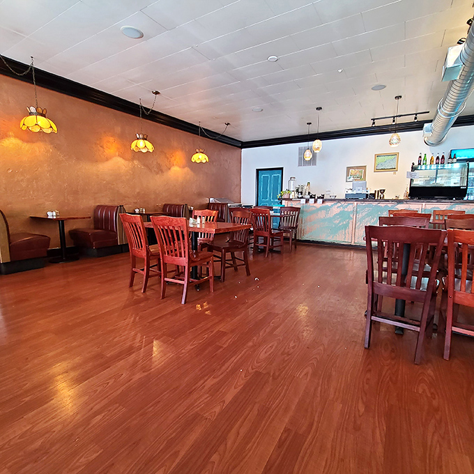 Warm amber lighting and rich wooden floors create the kind of cozy atmosphere that makes you want to linger over that second cup of coffee.