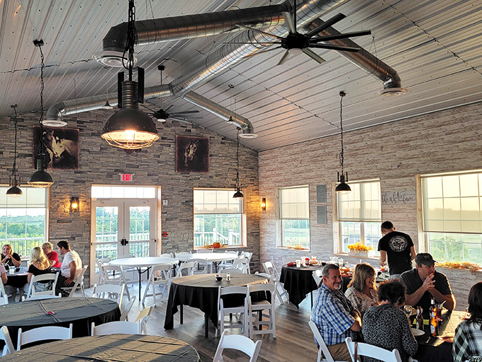 Industrial meets rustic in this airy dining space where stone walls, wooden floors, and pendant lighting create the perfect backdrop for memorable meals.