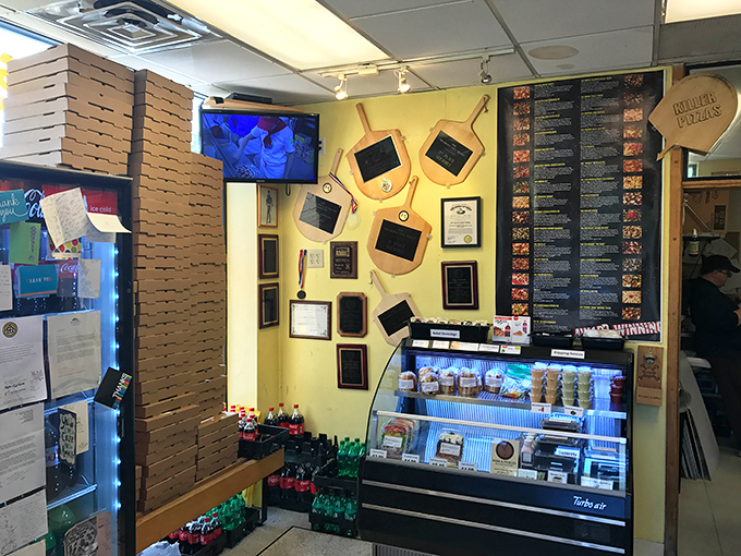Awards line the walls like trophies in a pizza hall of fame, a testament to dough-tossing excellence in this unassuming space.