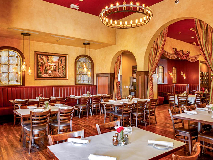 Warm golden walls, red leather booths, and elegant chandeliers create the perfect backdrop for both romantic dinners and family celebrations.