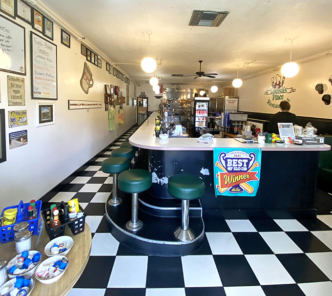 Classic black and white checkered floors meet teal counter stools in this time capsule of American diner perfection. Comfort never goes out of style.