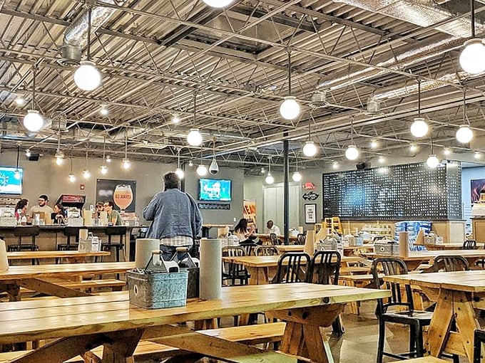 Industrial chic meets comfort at Old Scratch's communal dining space. The high ceilings and wooden tables create an atmosphere where strangers become friends over shared pizza wisdom.