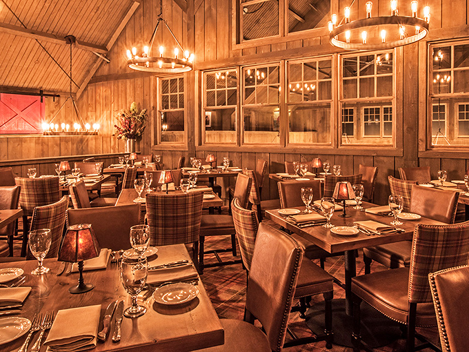 Rustic elegance defined: warm wood paneling, circular chandeliers, and plaid accents create an atmosphere where comfort meets sophistication.