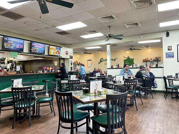 Classic diner geometry: green chairs, ceiling fans, and the gentle hum of conversation that makes breakfast feel like coming home.