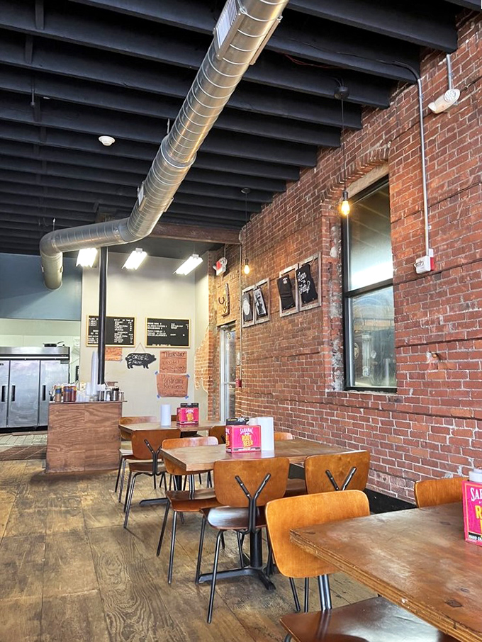 Industrial chic meets meat sanctuary. The exposed brick and ductwork create the perfect backdrop for the serious business of barbecue appreciation.
