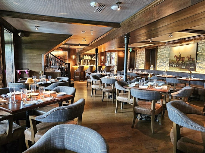 Dark wood, plush seating, and equestrian artwork create the perfect atmosphere for important decisions—like whether to order the ribeye or filet mignon.