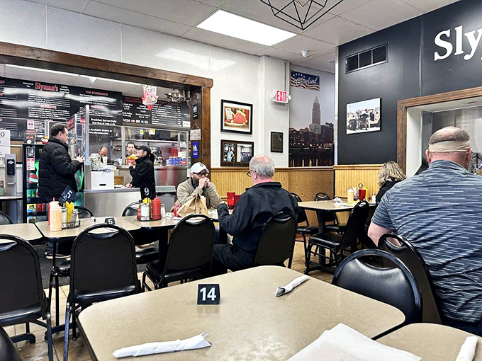 Inside Slyman's, the no-frills dining area buzzes with anticipation. Every table tells a story, while the counter promises sandwich salvation just moments away.