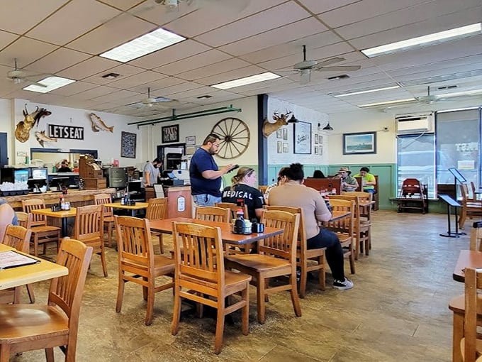 Inside, wooden tables and chairs have witnessed countless conversations while "LET'S EAT" signs state the obvious mission that brings everyone together.
