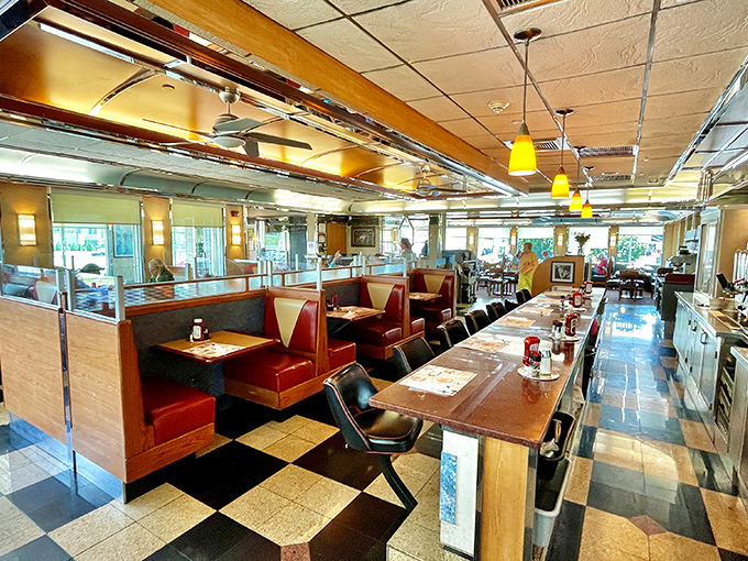 Classic black and white checkered floors lead you past cozy red booths where countless conversations have unfolded over steaming cups of coffee.