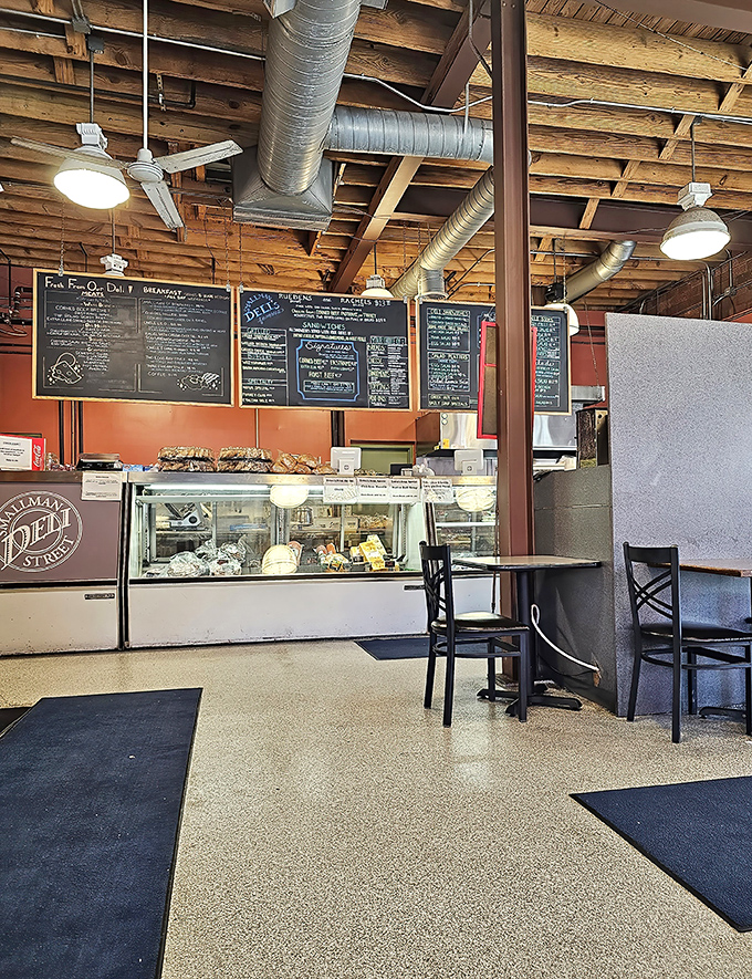 Industrial chic meets comfort food haven &ndash; exposed beams and ductwork watch over a space where sandwich artistry happens daily.