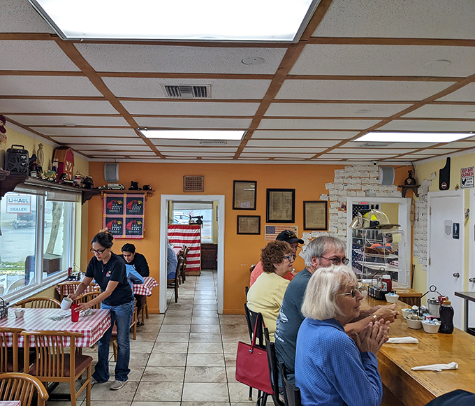 Orange walls and checkered floors create the perfect backdrop for your morning breakfast adventure.