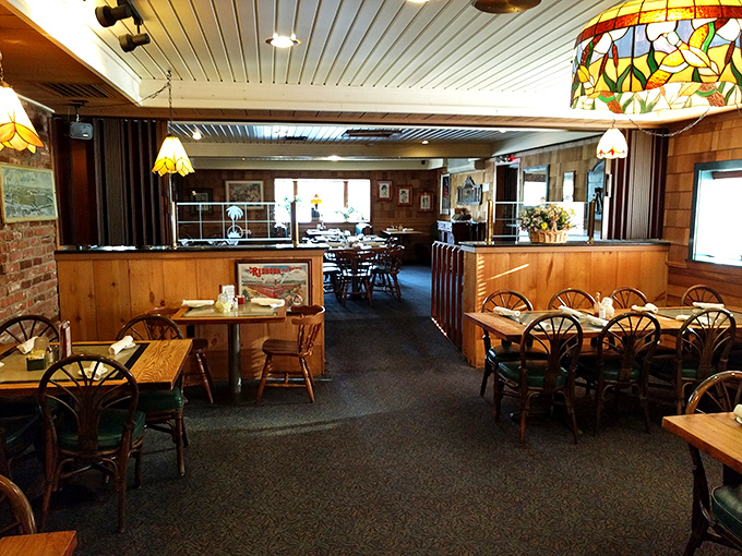 Warm wood paneling and Tiffany-style lamps create that perfect "come stay awhile" atmosphere where memorable meals and conversations naturally unfold.