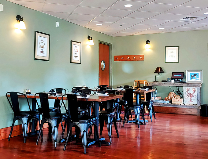 Modern meets maritime in this dining space where seafood-themed artwork adorns soft green walls and sleek metal chairs invite you to settle in for oceanic delights. 