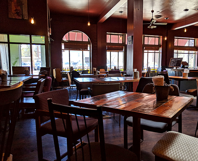 Rustic wooden tables bathed in natural light create the perfect setting for both serious conversations and casual people-watching.