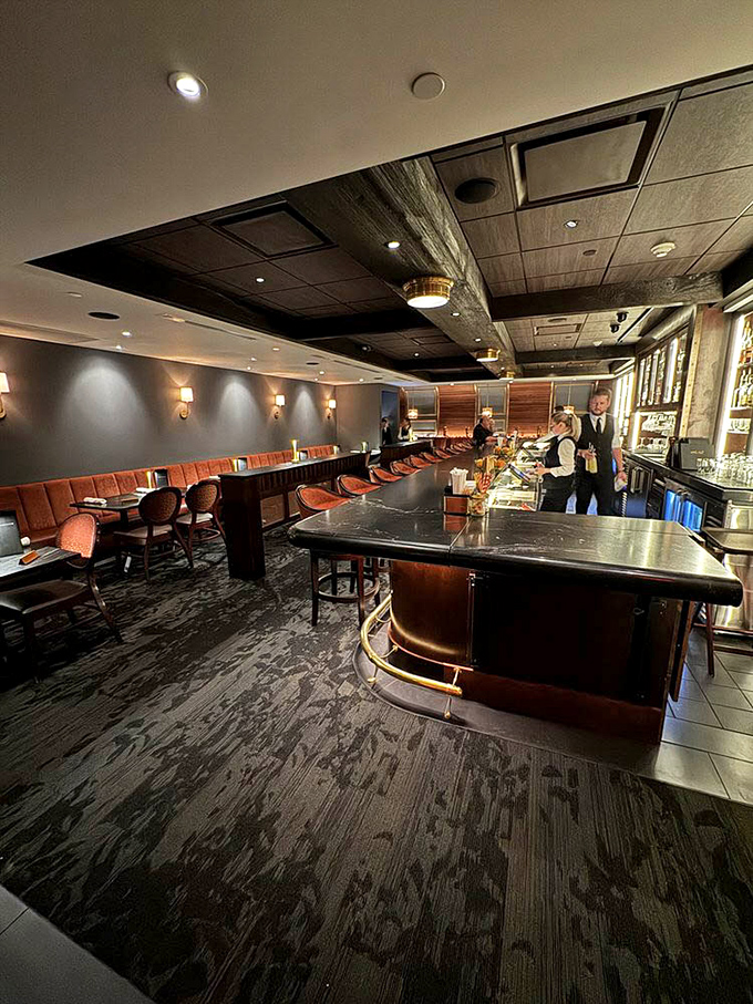 The elegant bar area whispers of old-world luxury, where cocktails are crafted with the reverence usually reserved for religious ceremonies.