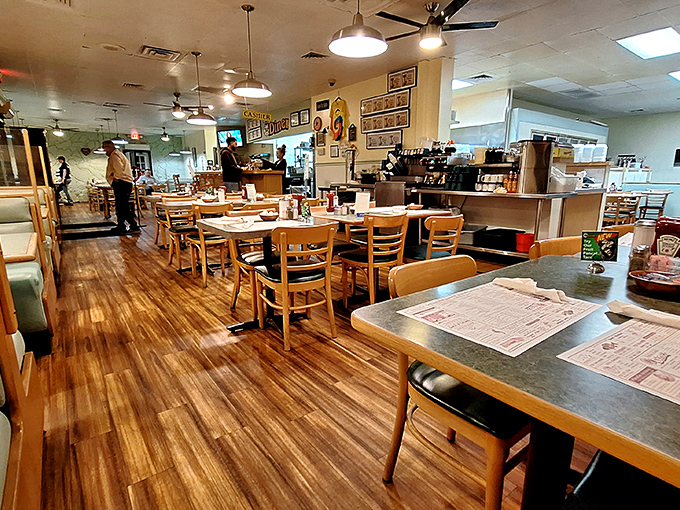 Inside, warm wood floors and simple furnishings create that perfect diner atmosphere where conversations flow as freely as the coffee.