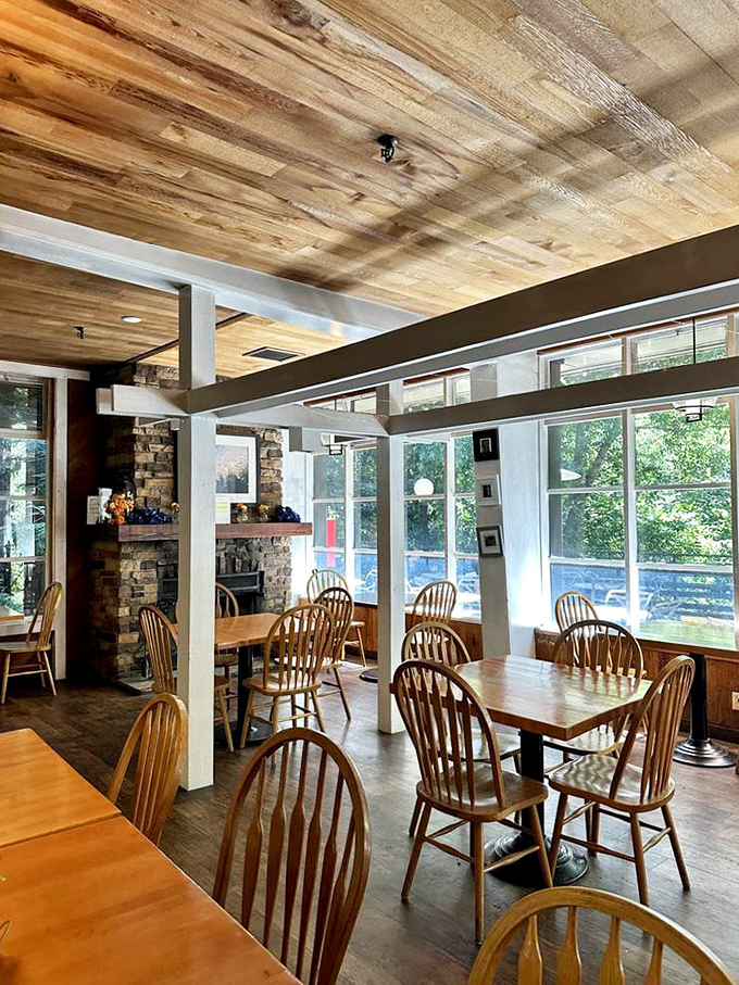 Wooden beams, natural light, and Windsor chairs create the perfect rustic-chic atmosphere. Like dining in a cabin designed by someone with actual taste.
